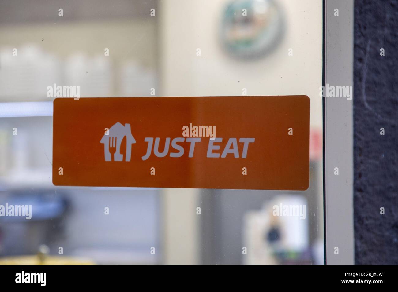 Bordeaux , France - 08 18 2023 : just eat sign brand and facade door ...