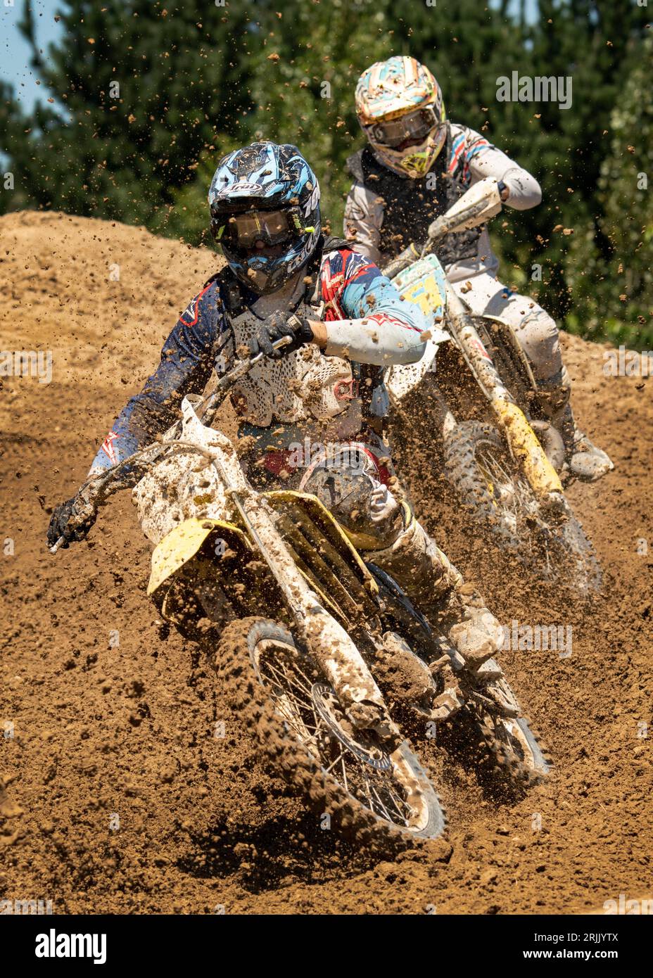 Two adult males enjoying an outdoor adventure on off-road dirt bikes ...