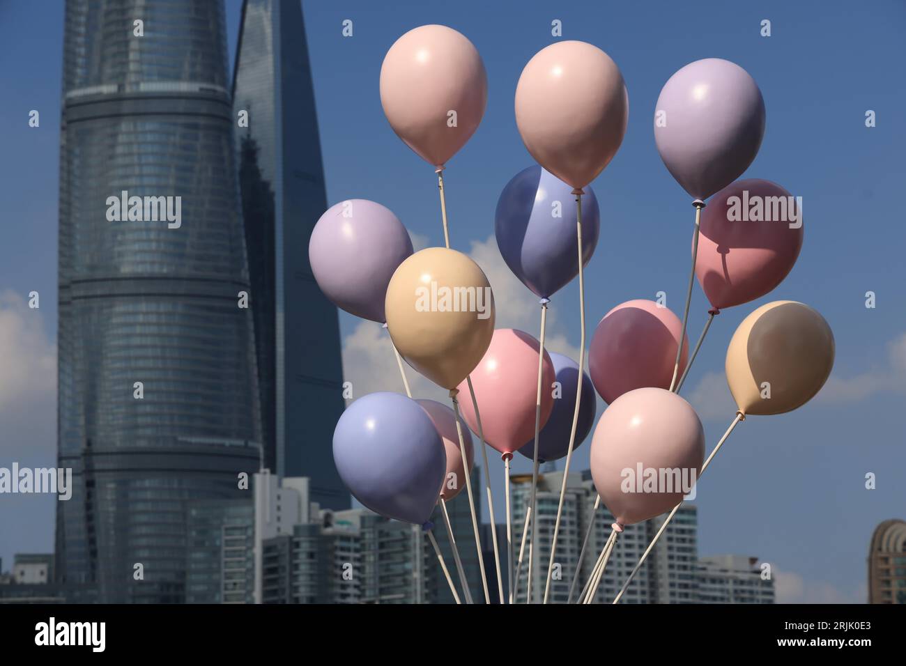 Tourists take photos of a large balloon art installation at the Bund in ...