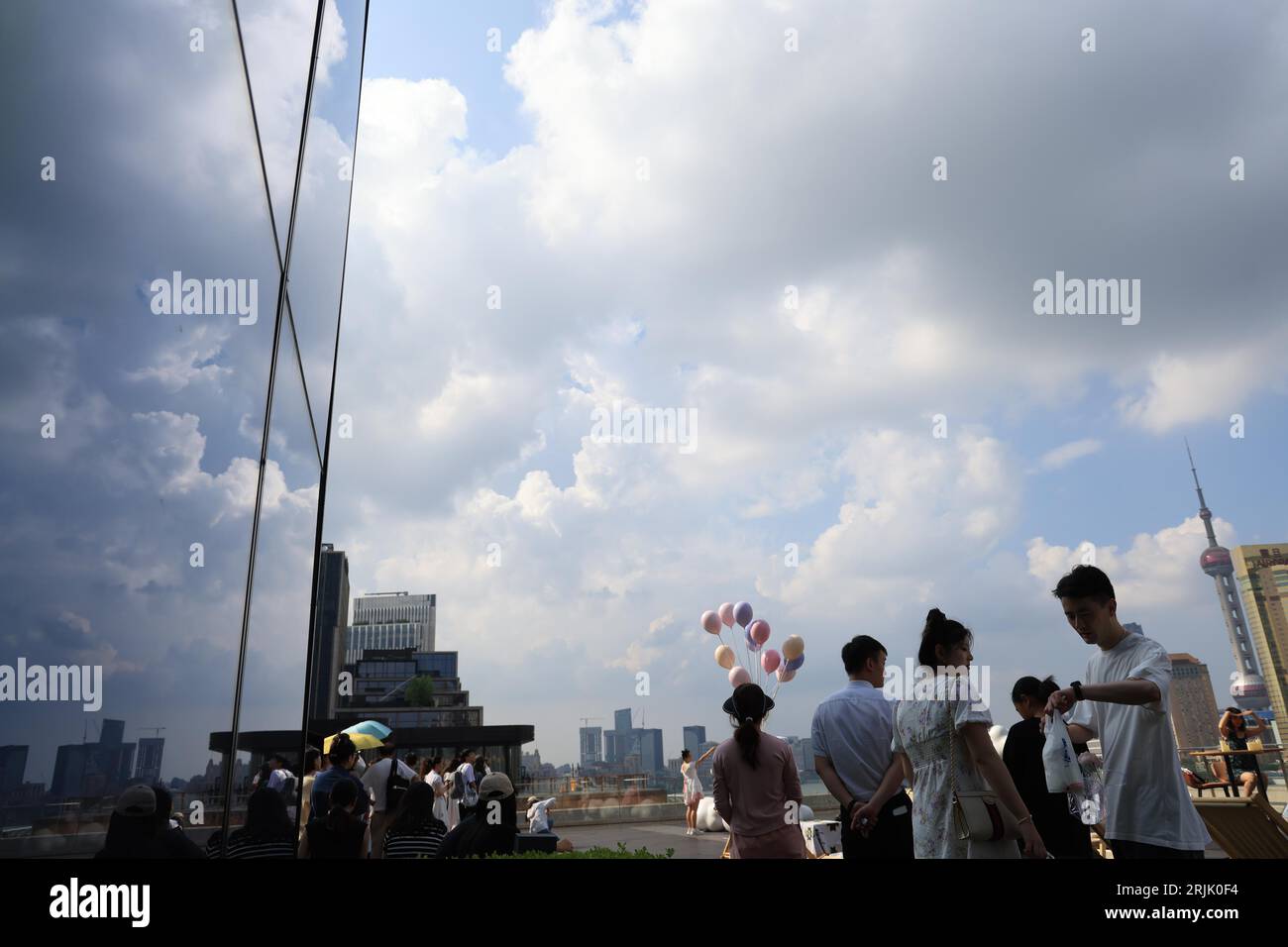 Tourists take photos of a large balloon art installation at the Bund in ...