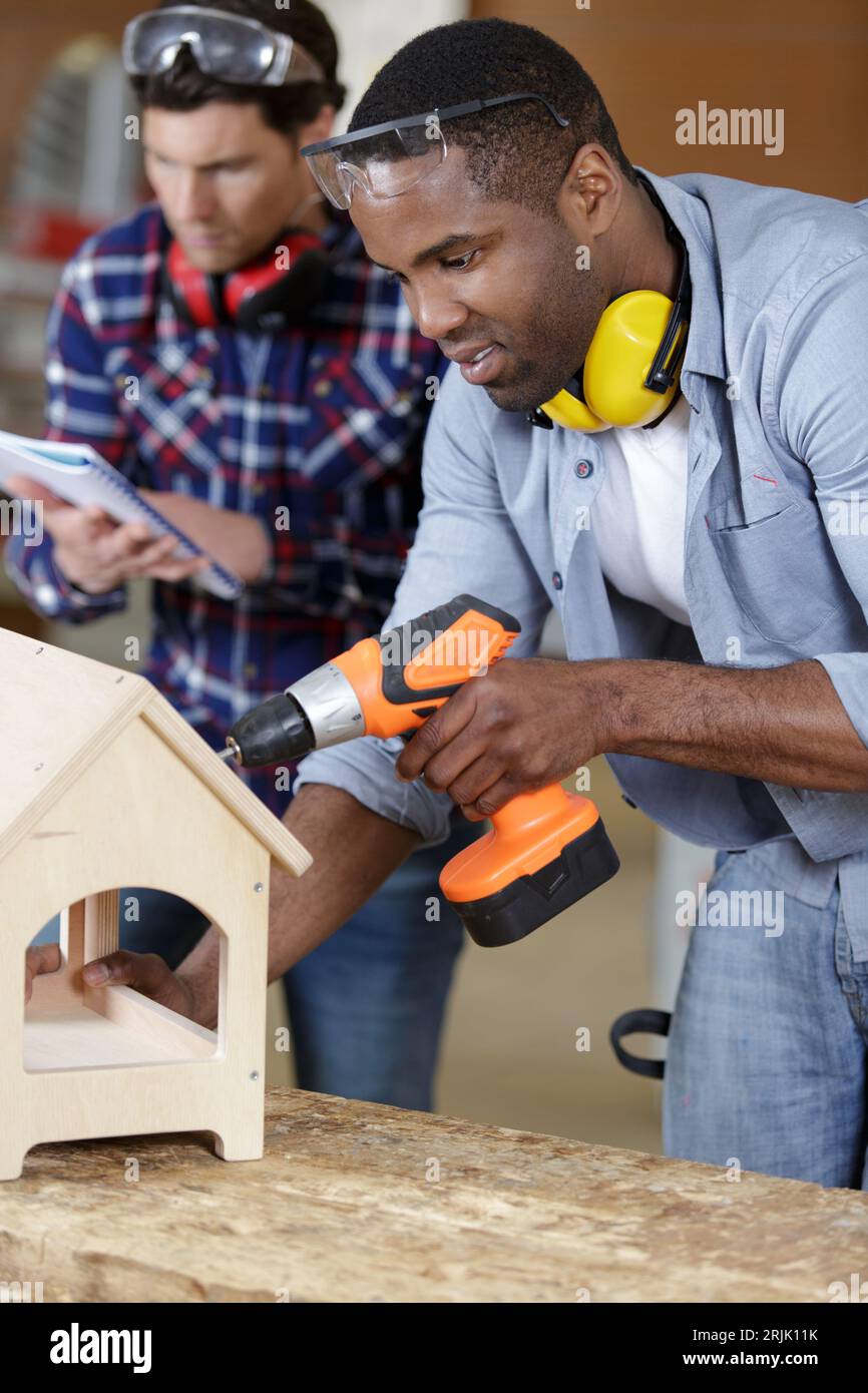 Two men drilling hole hi-res stock photography and images - Alamy