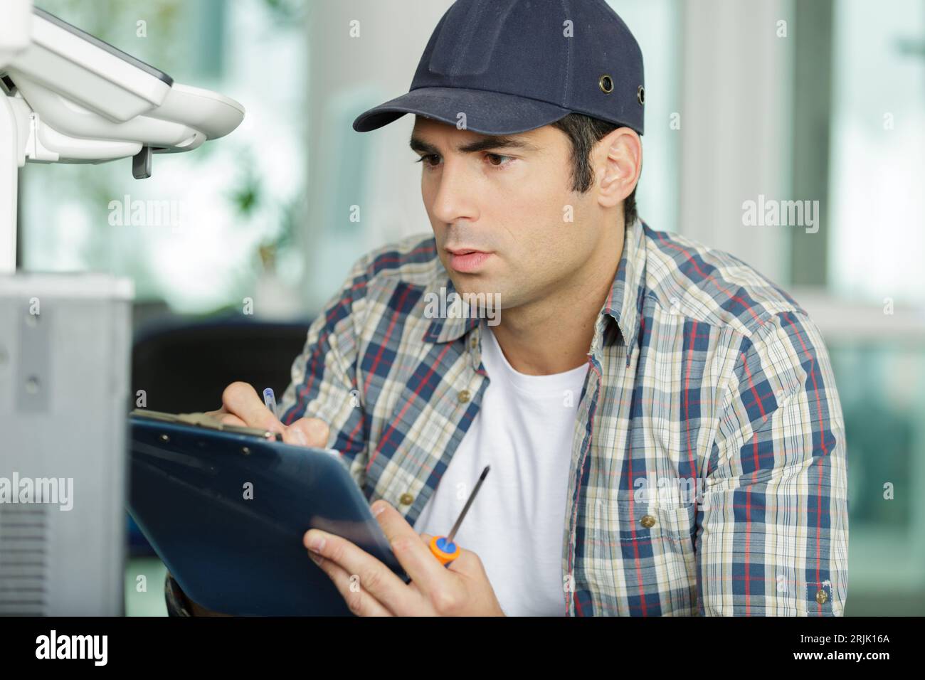 male technician fixing a printer Stock Photo - Alamy