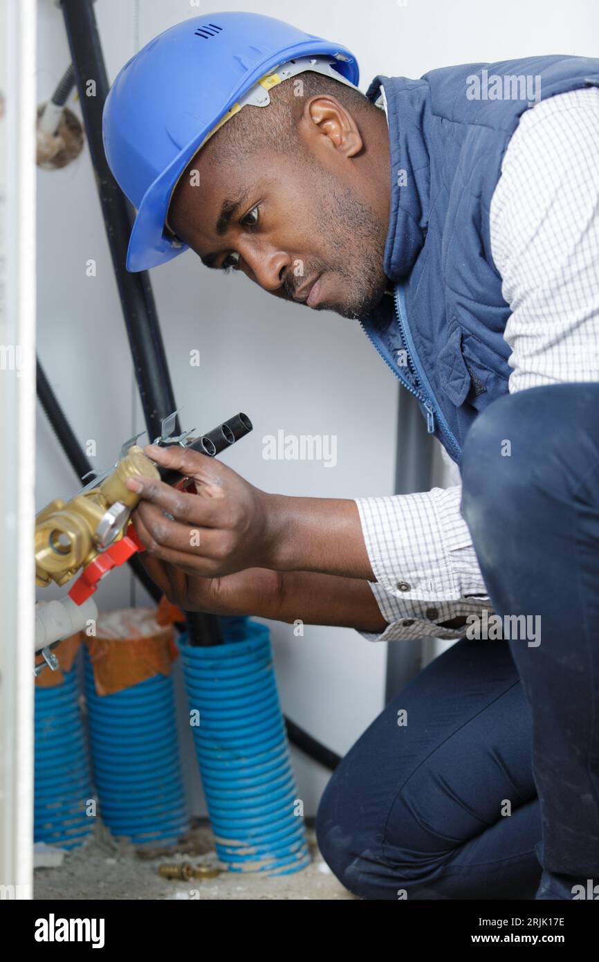 Technician holding water pipes hi-res stock photography and images - Alamy