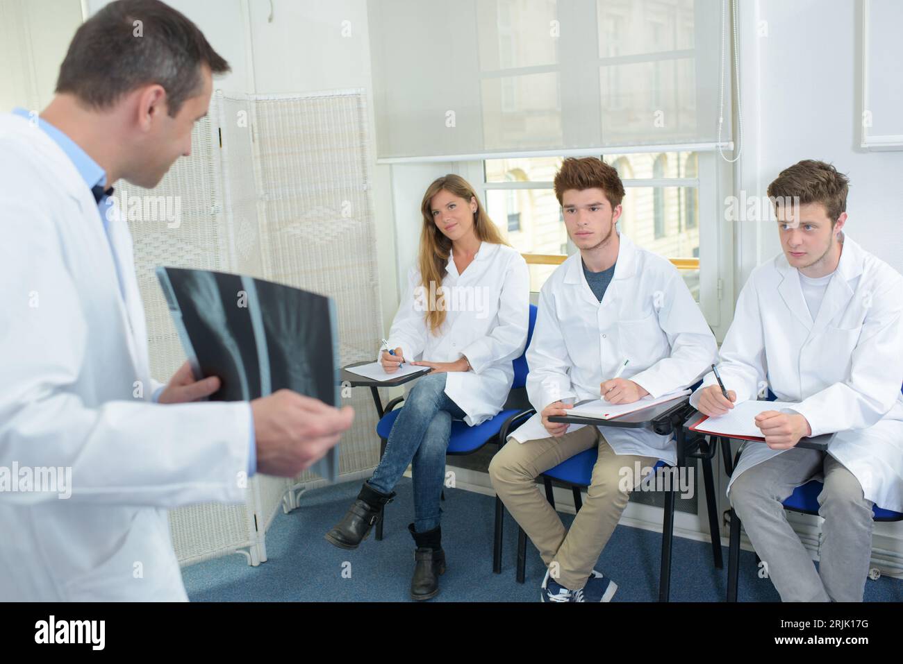 Doctor showing xray to seated students Stock Photo - Alamy