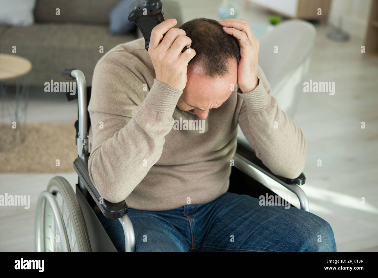 side view of sad man sitting on wheelchair Stock Photo - Alamy