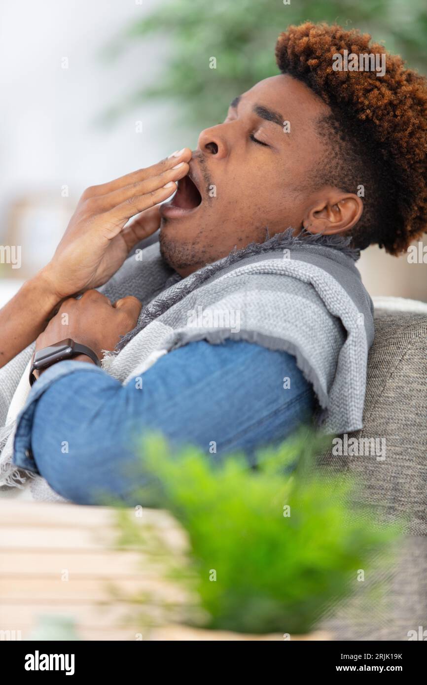 Sleepy young african man yawning hi-res stock photography and images ...