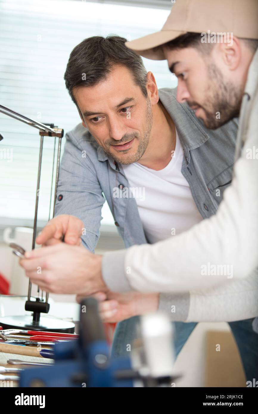 two men working as craftsmen together in carpenters shop Stock Photo ...