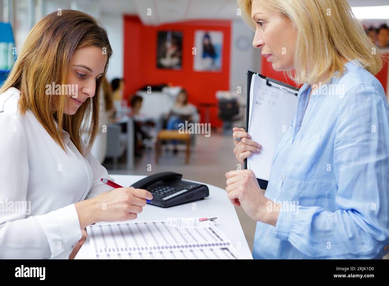 receptionist and manager at beauty salon reception Stock Photo - Alamy