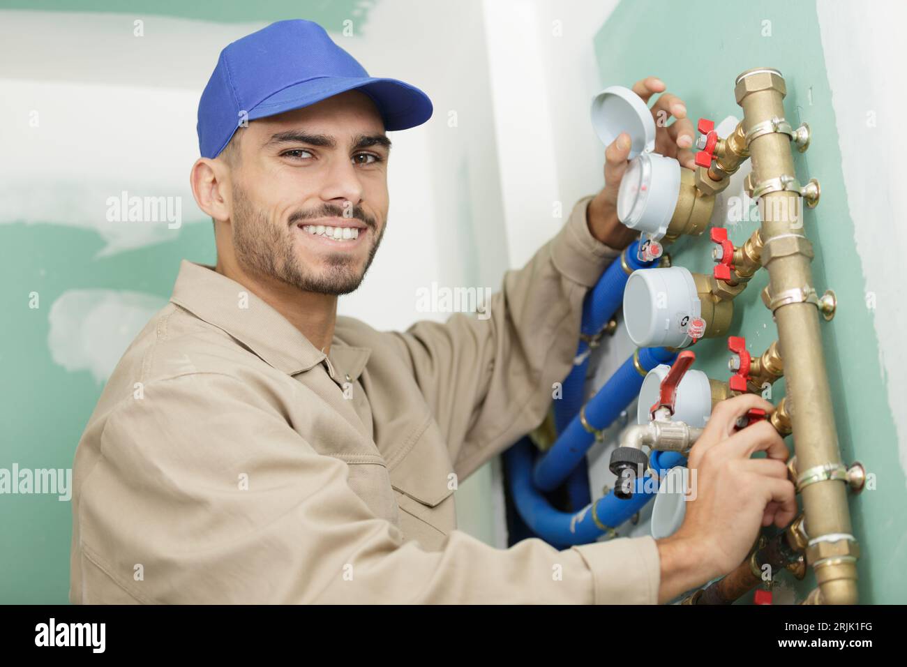 a happy water meter installer Stock Photo - Alamy