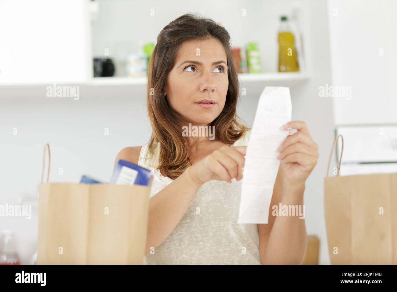 pensive young lady checking her shopping receipt Stock Photo - Alamy
