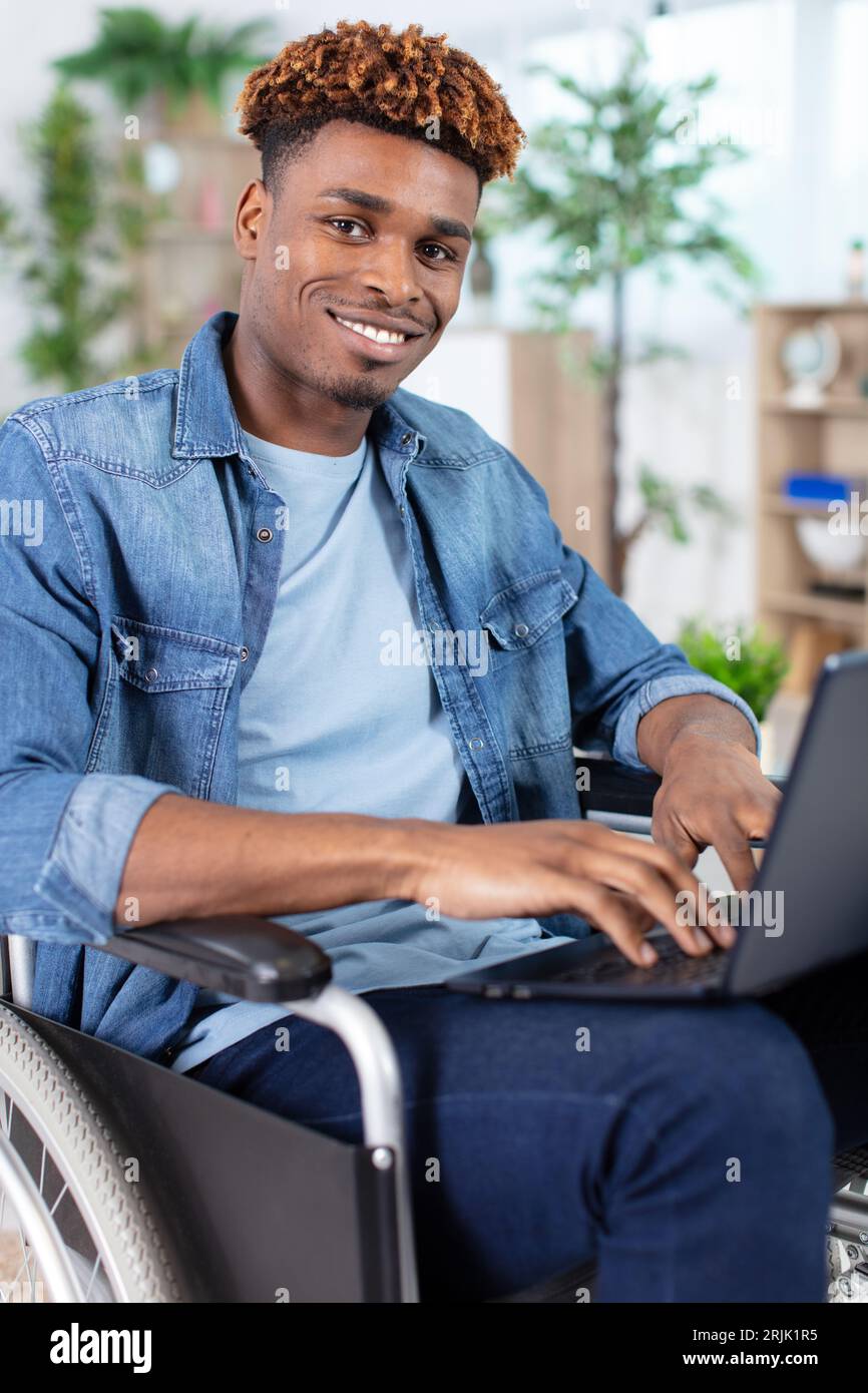 disabled teenage male student working on a laptop Stock Photo - Alamy