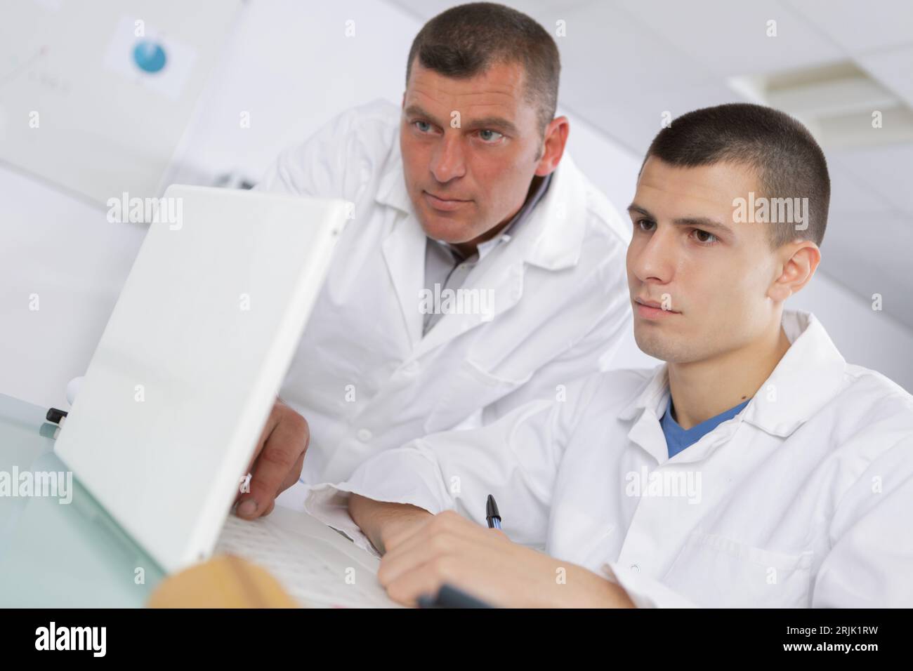 successful teamwork inside the lab researching on laptop Stock Photo ...
