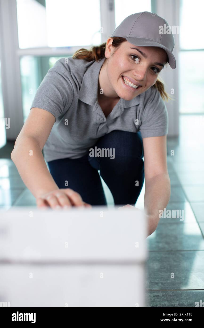 happy female janitor cleaning the floor Stock Photo - Alamy