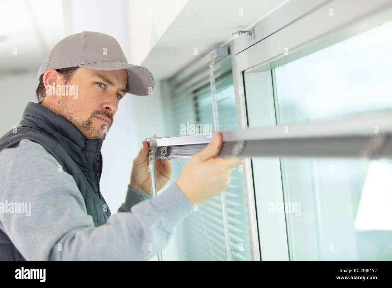 man installing window blinds in a house Stock Photo - Alamy