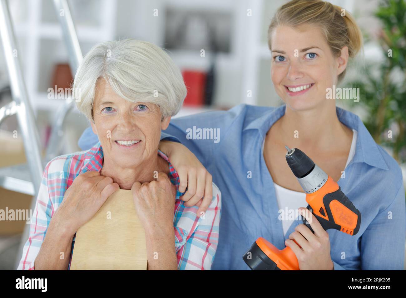 mum and daughter doing diy Stock Photo - Alamy