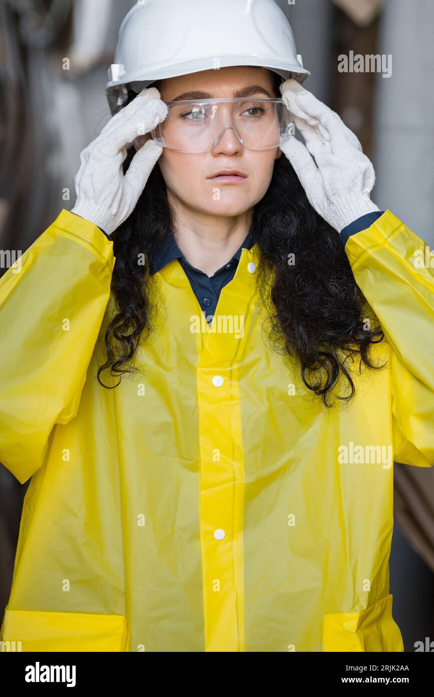 Female worker supervising process at waste disposal factory Stock Photo ...