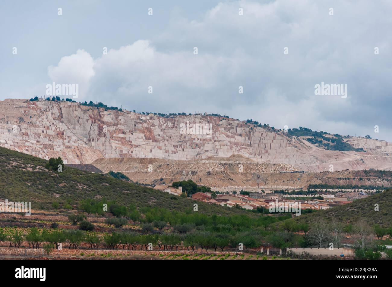 view of an open pit marble quarry showing heavy duty equipment and rock ...
