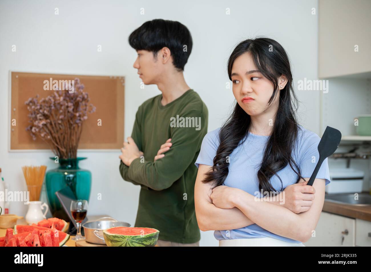 Unhappy and angry young Asian couple ignoring each other, feeling ...