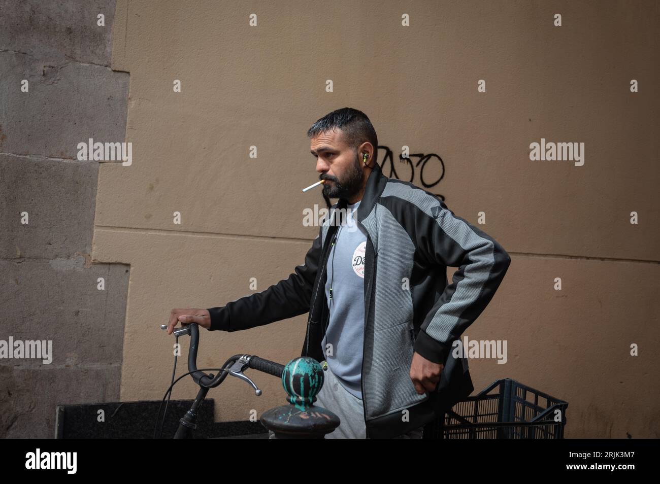 Street photography portrait of a young foreigner with a bicycle through ...