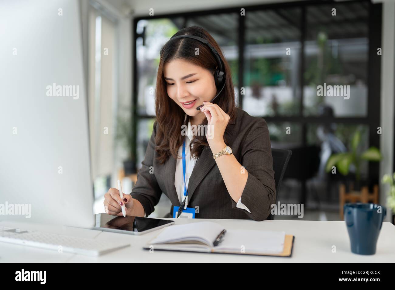 Call centre operator using telephone hi-res stock photography and ...