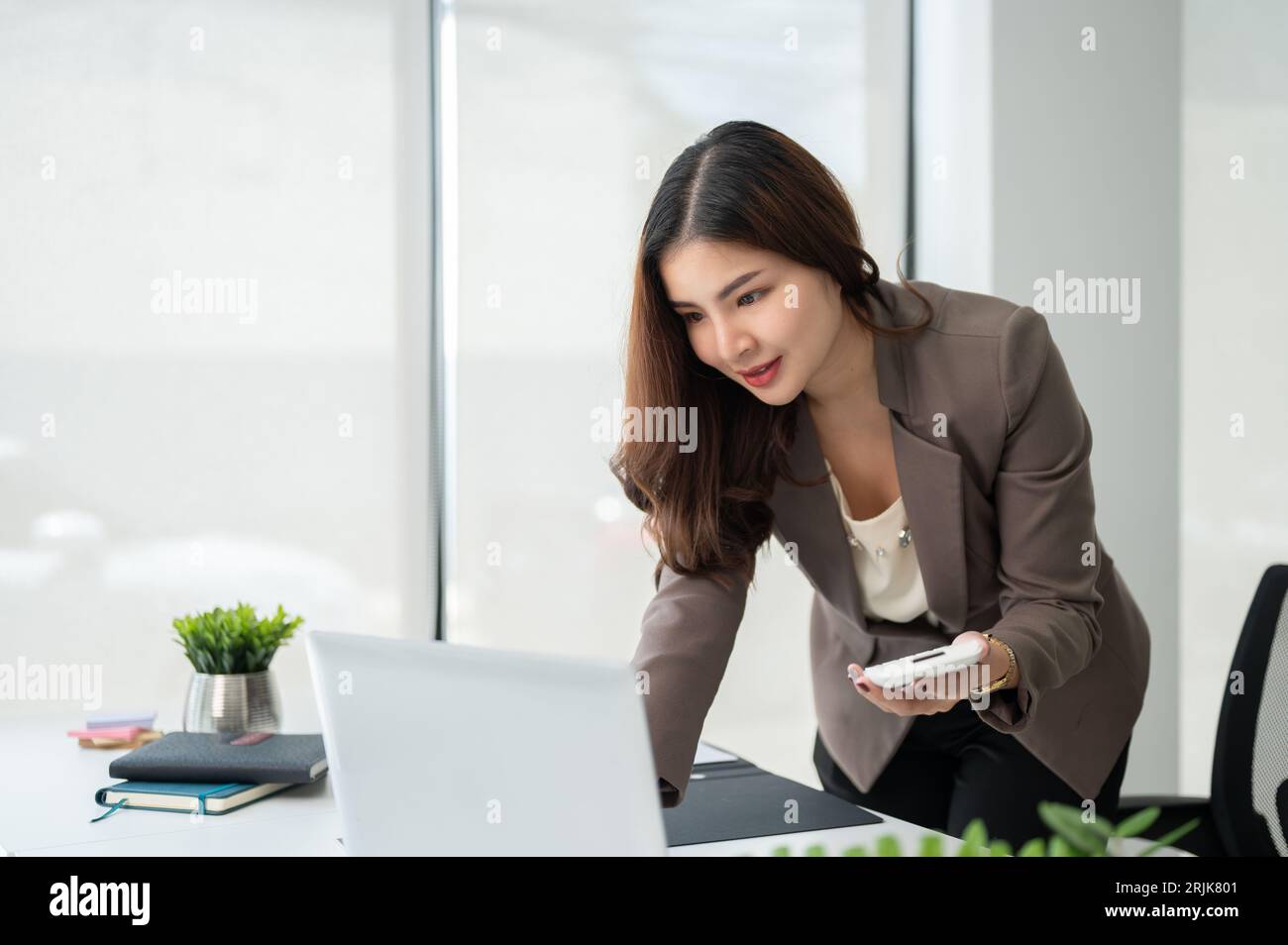 Woman bending over table holding hi-res stock photography and images ...