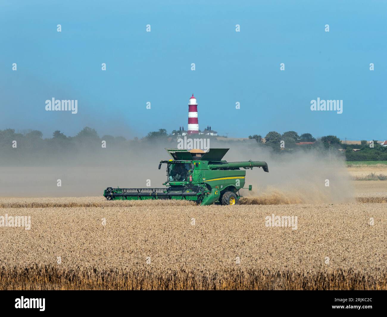 Combine harvesting with Happisburgh Light House Norfolk August Stock ...