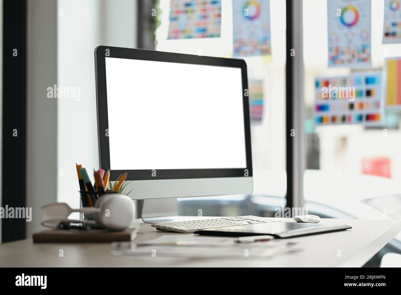 Creative designer workplace with blank computer monitor, headphone and ...