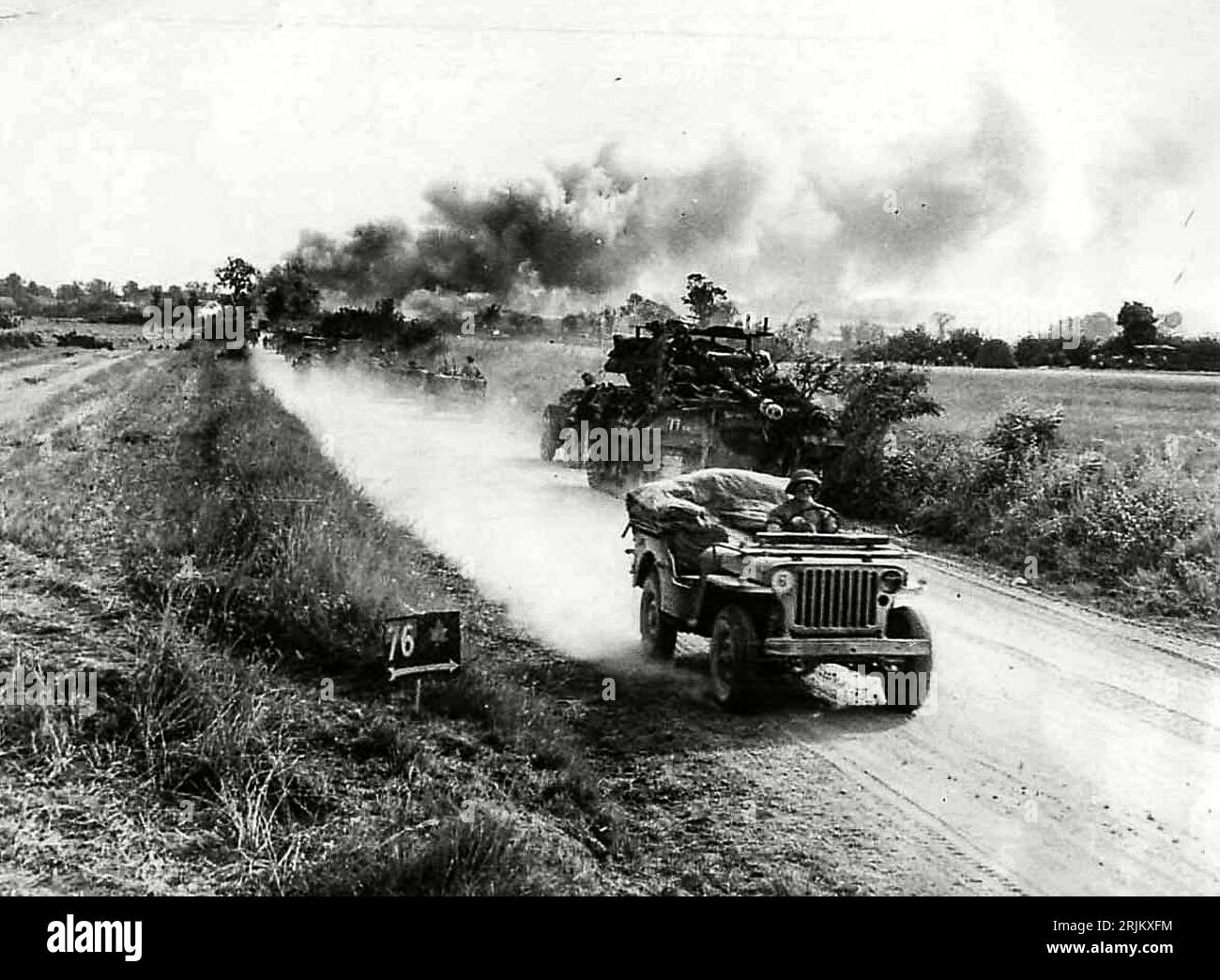 World War II - FRANCE. Invasion of Normandy 1944, Troops pass burning ...