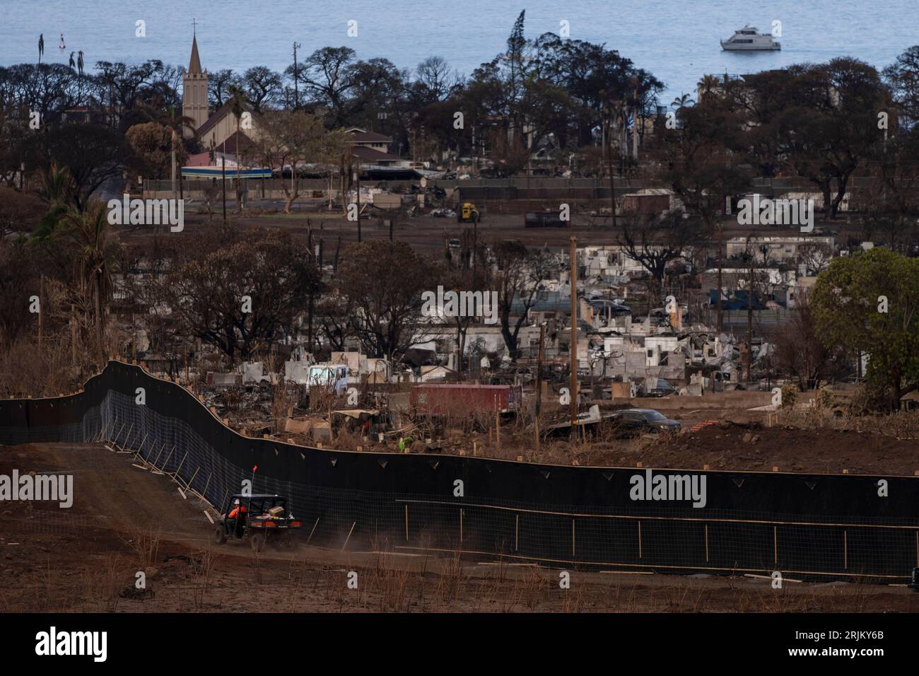 A fence is built around properties consumed by a wildfire in Lahaina ...