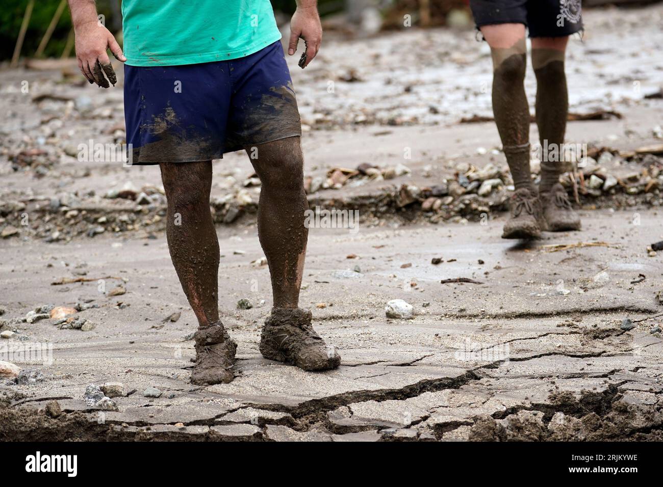 Residents Brooke Horspool, left, and his son Andrew Horspool show mud ...
