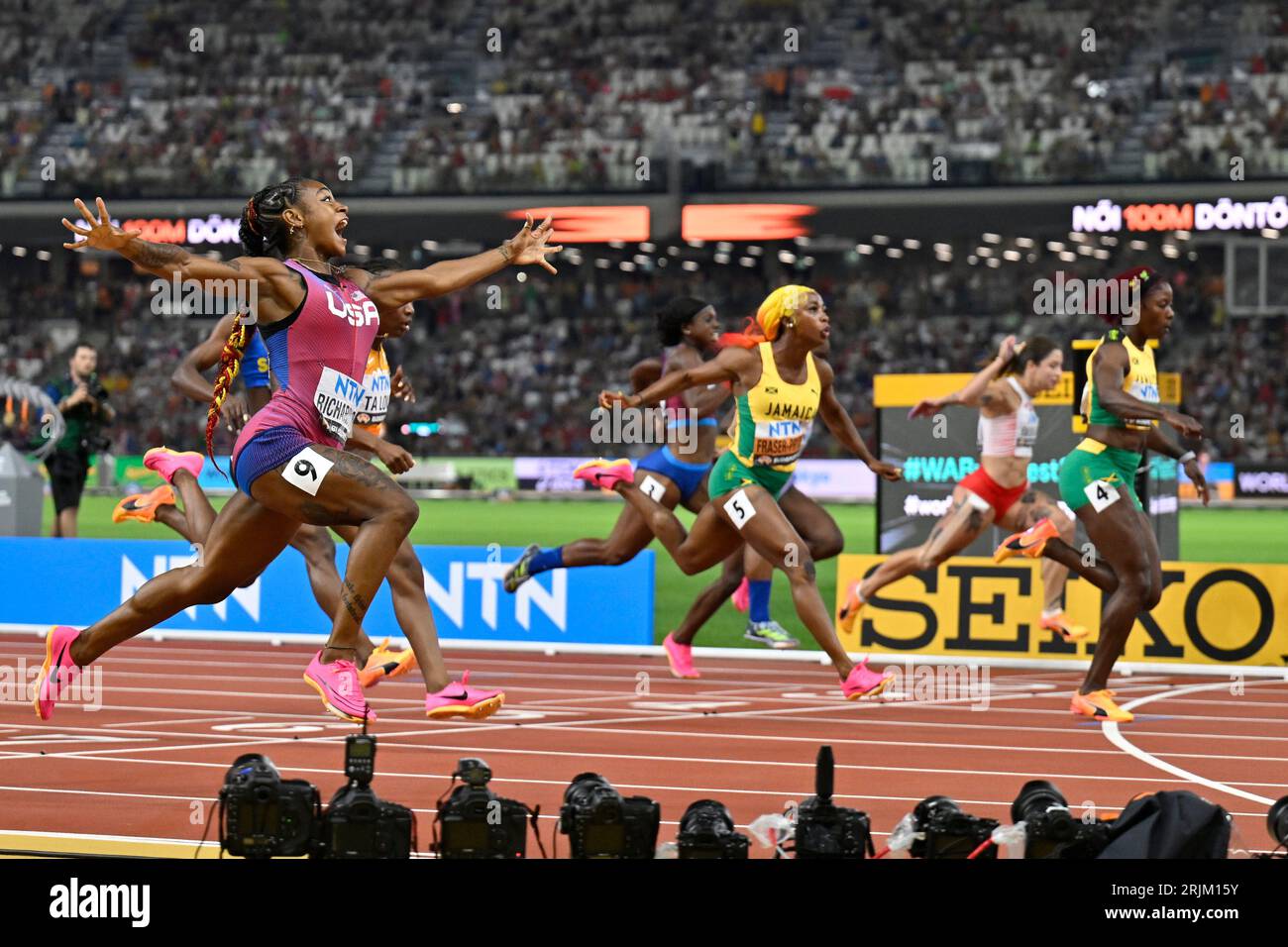 Sha'Carri Richardson, of the United States, spreads her arms as he ...