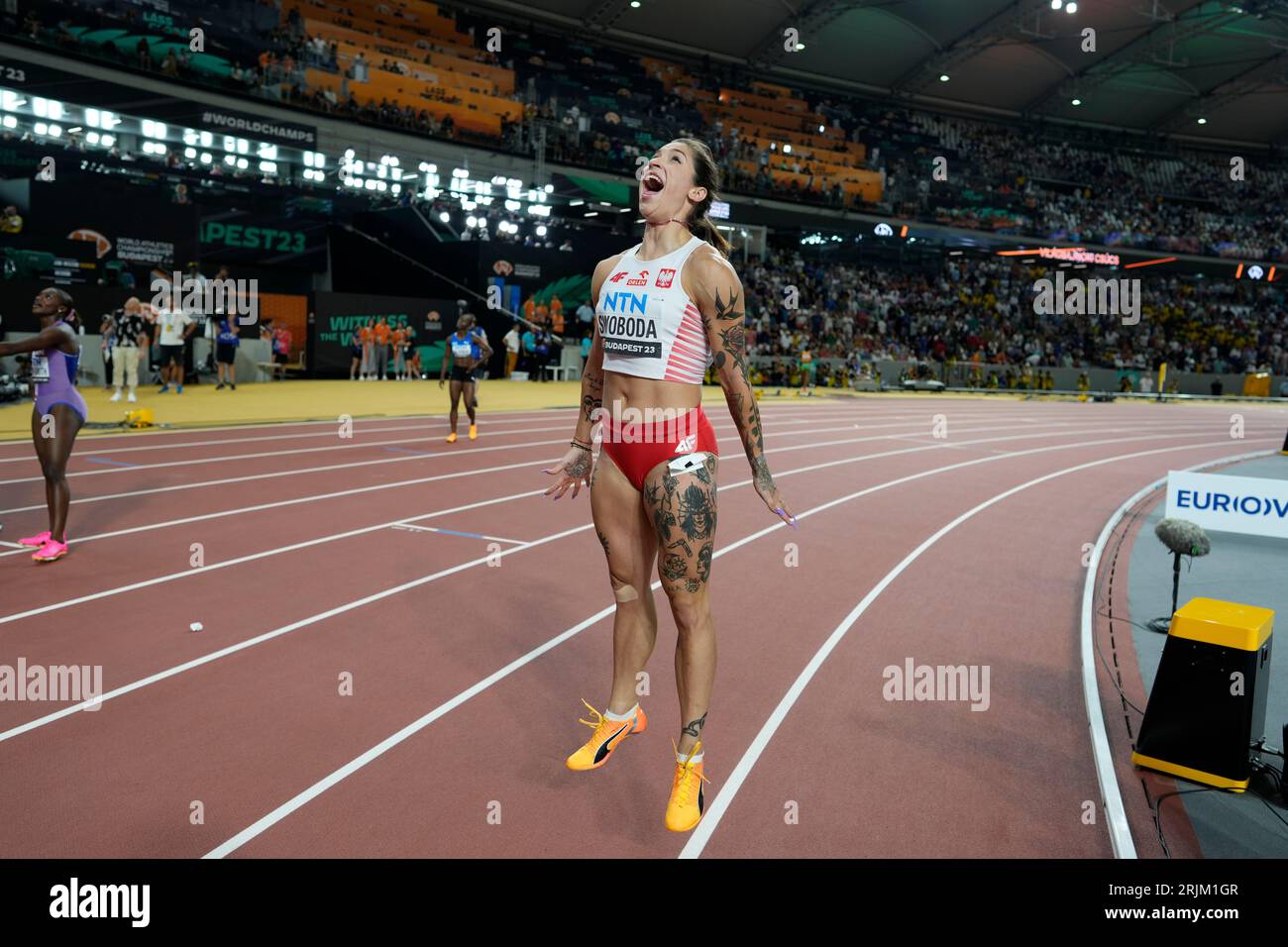 Ewa Swoboda, of Poland, reacts after crossing the finish line in the ...