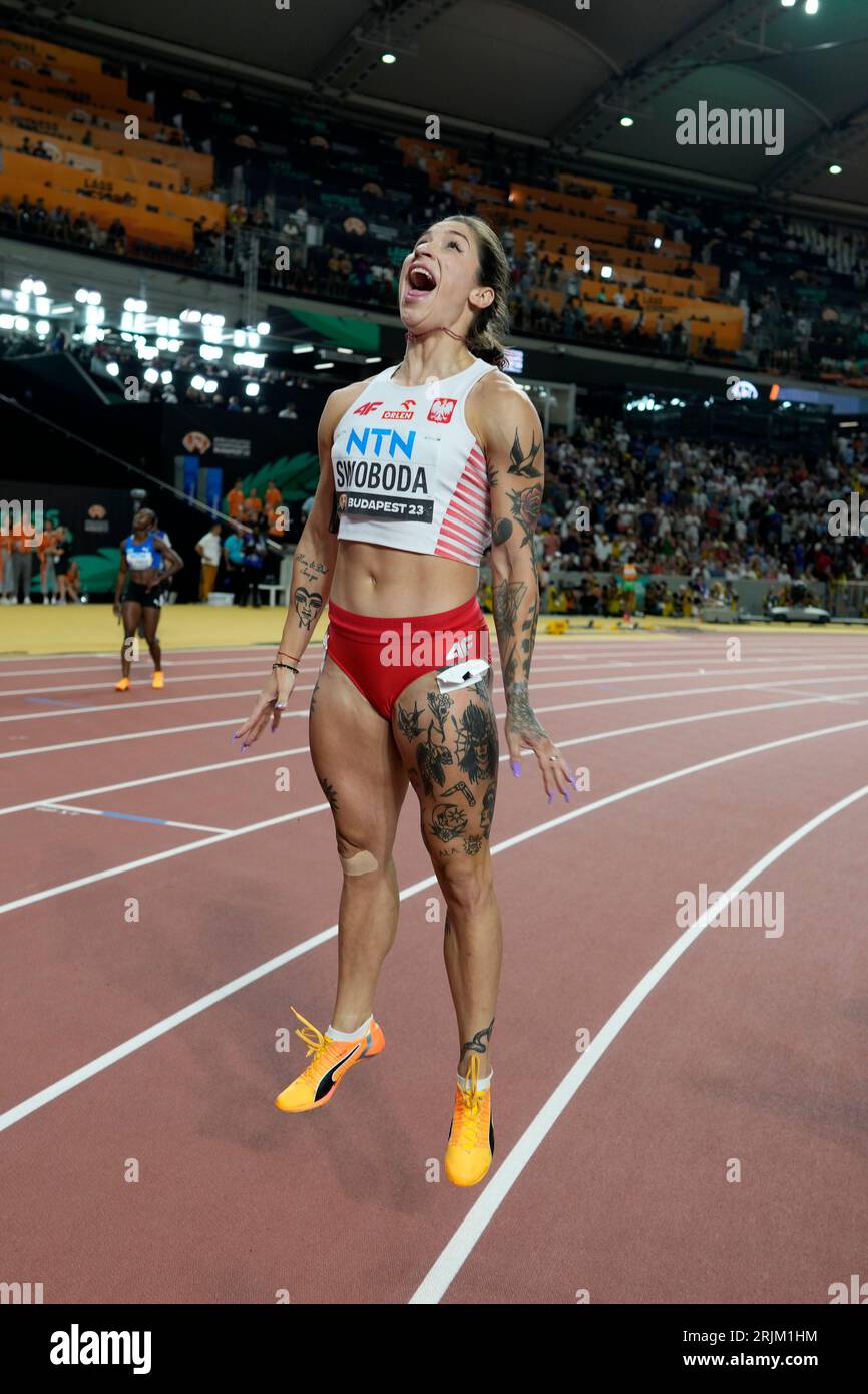 Ewa Swoboda, of Poland, reacts after crossing the finish line in the ...