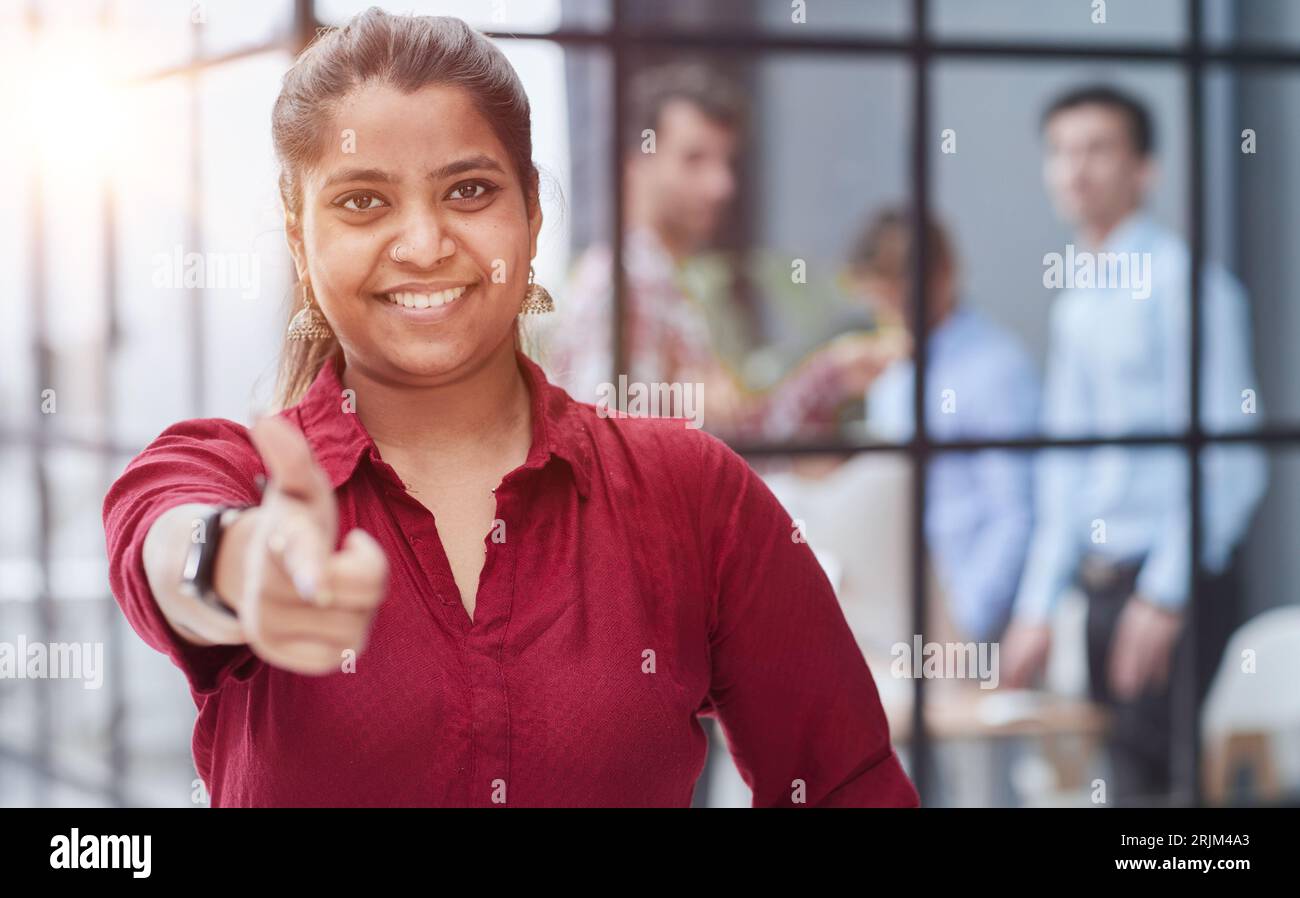 Young woman is pointing at the camera with her hands. Hey you come here ...