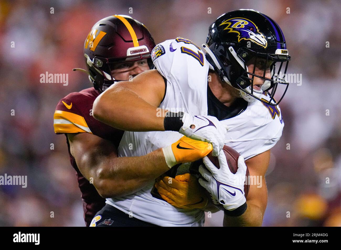 Washington Commanders linebacker David Mayo, back, tackles Baltimore ...