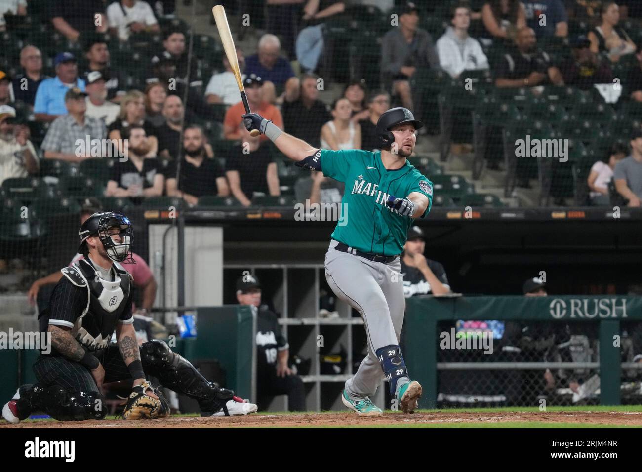 Seattle Mariners' Cal Raleigh, right, watches his three-run home run ...