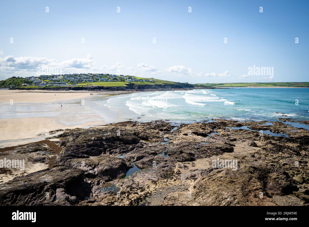 A stunning beach with light beige sand and light blue waters next to a ...