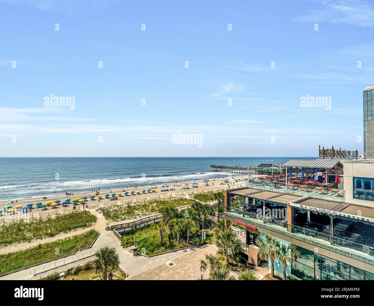 An aerial view of a grand beachfront structure situated on a sandy ...