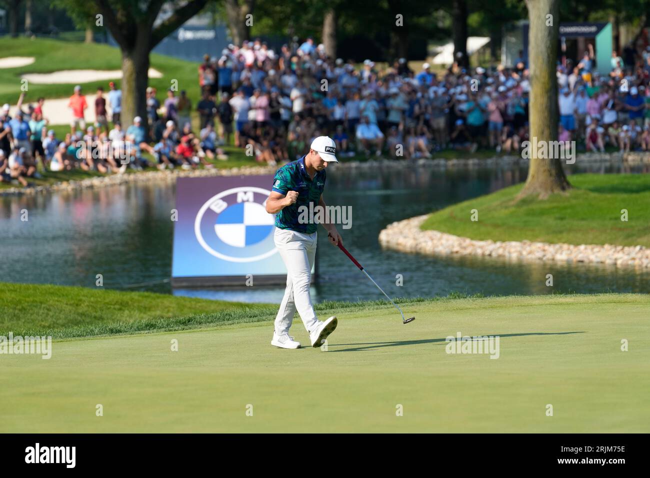 Viktor Hovland reacts after making his birdie putt on the 18th green during the final round of ...