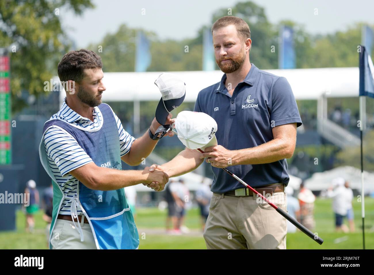 Chris Kirk, right and caddie Michael Cromie have an extended handshake ...