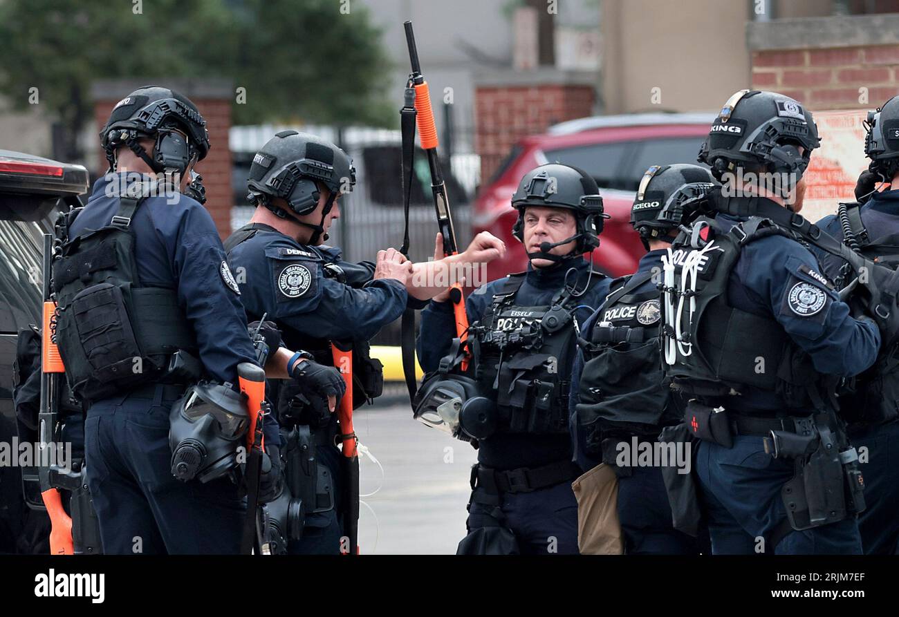 The St. Louis police SWAT team gathers in front of the city jail in ...