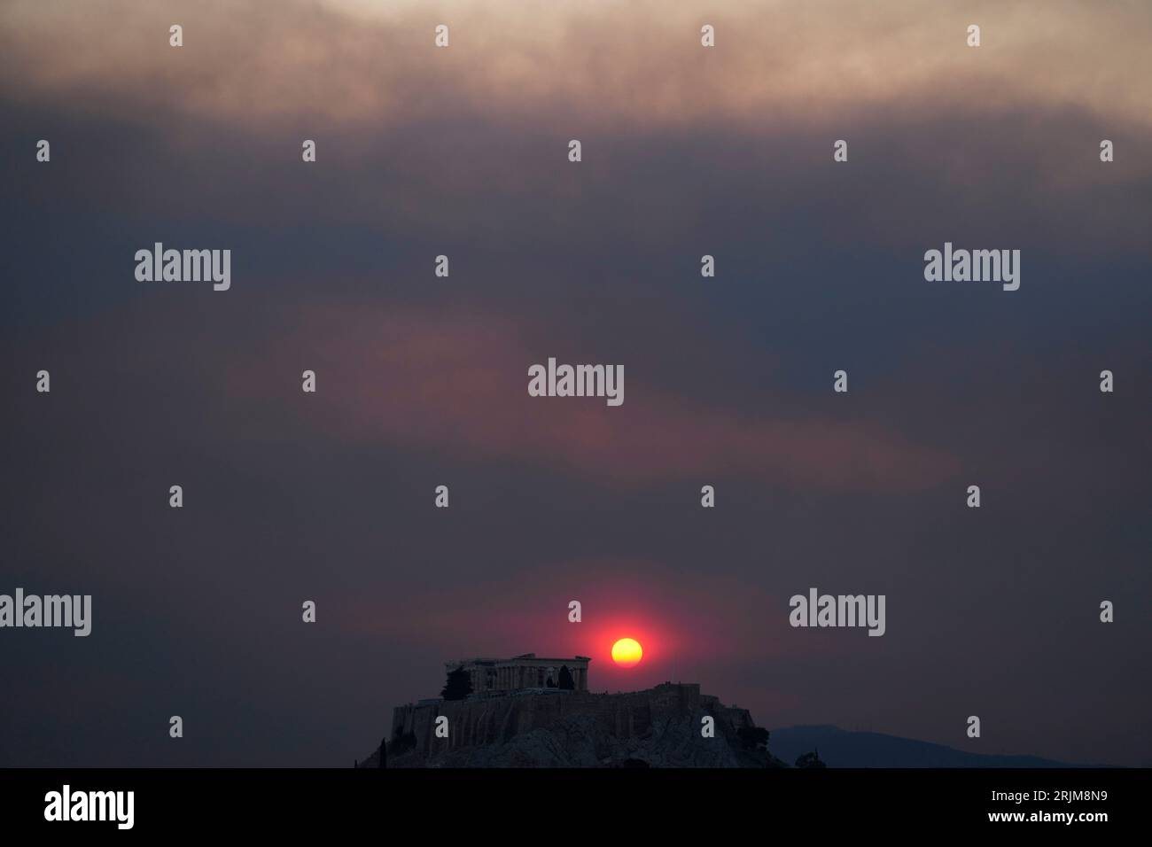 Smoke from a wildfire in the outskirts of the Greek capital covers the ...