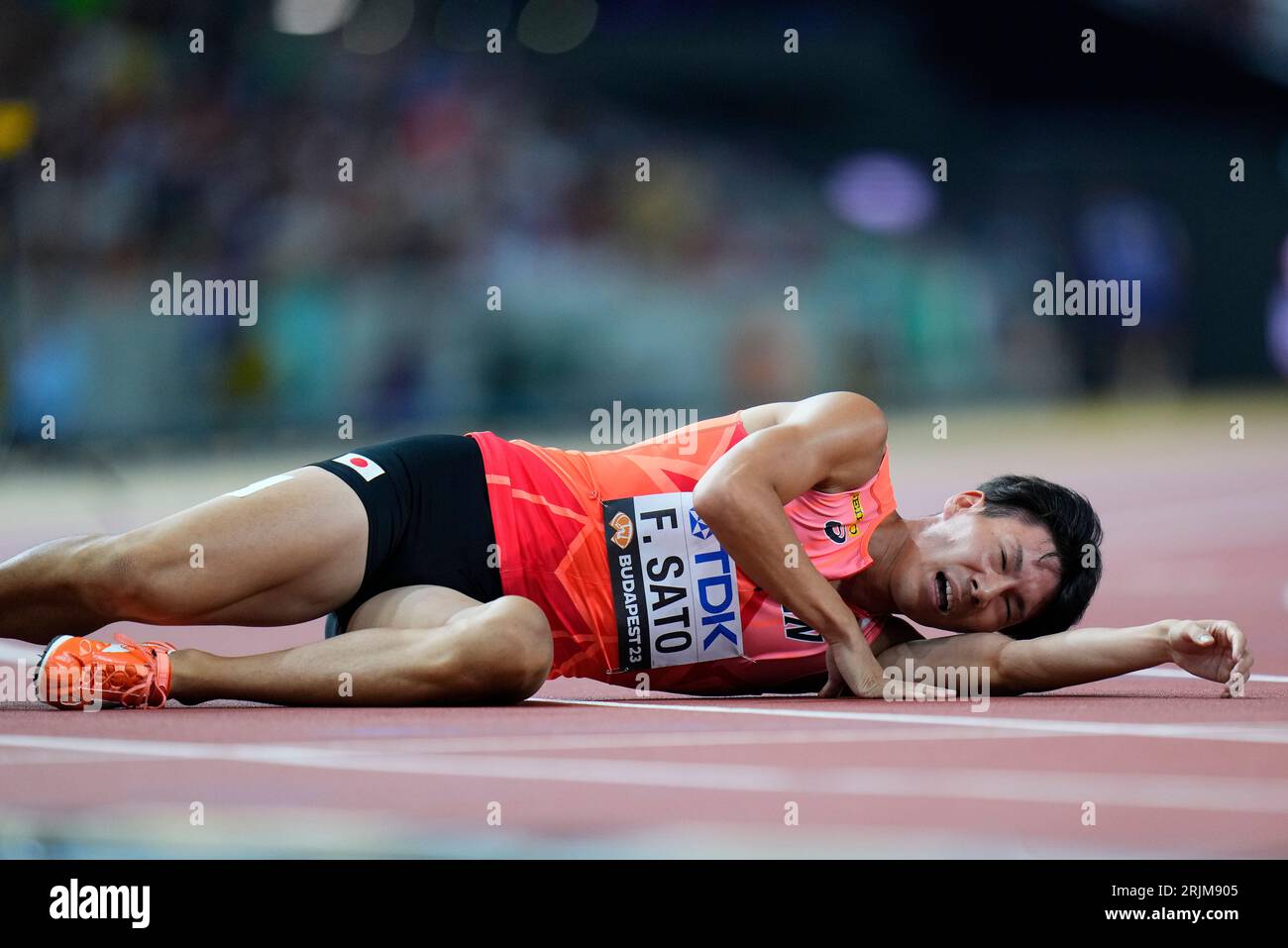 Fuga Sato, of Japan lays on the track after finishing a Men's 400 ...