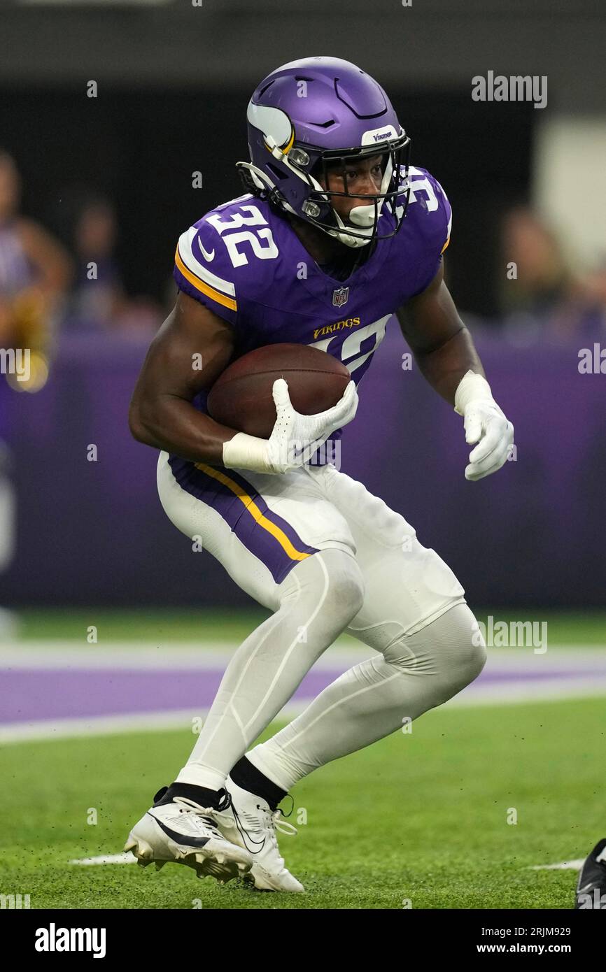 Minnesota Vikings running back Ty Chandler carries the ball up field ...