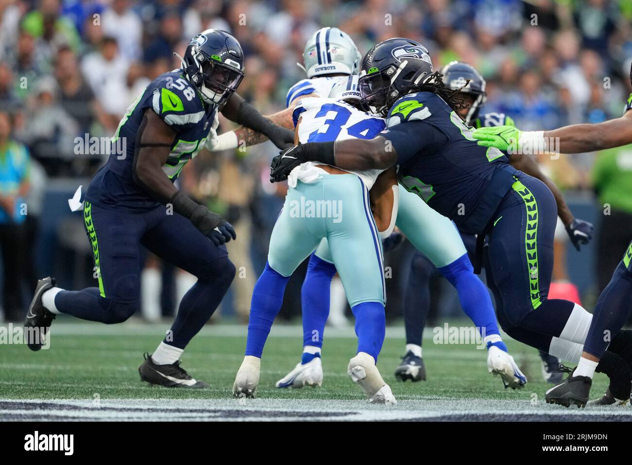 Dallas Cowboys running back Malik Davis is tackled by Seattle Seahawks ...
