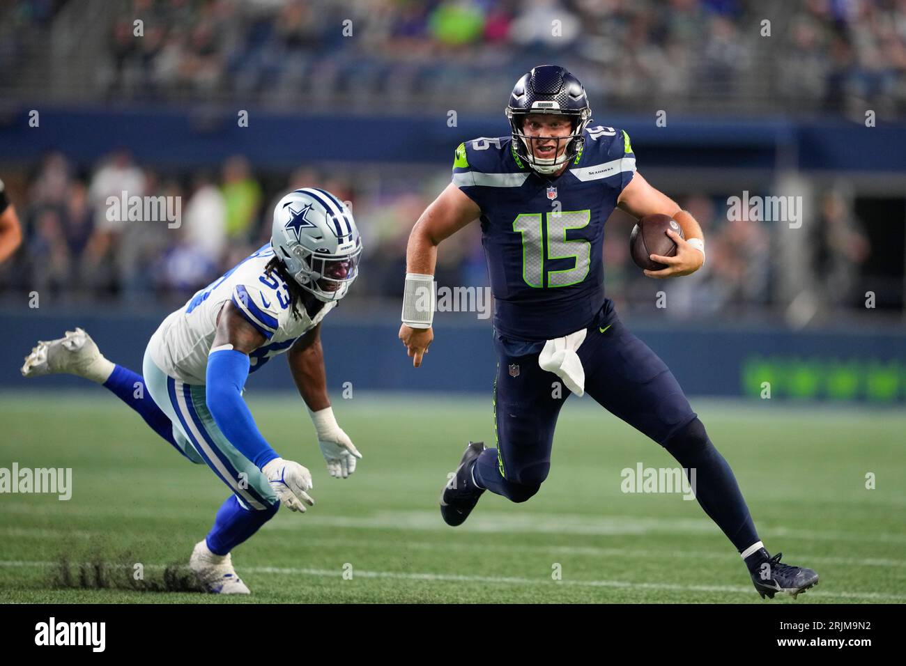 Seattle Seahawks quarterback Holton Ahlers (15) avoids the tackle from ...
