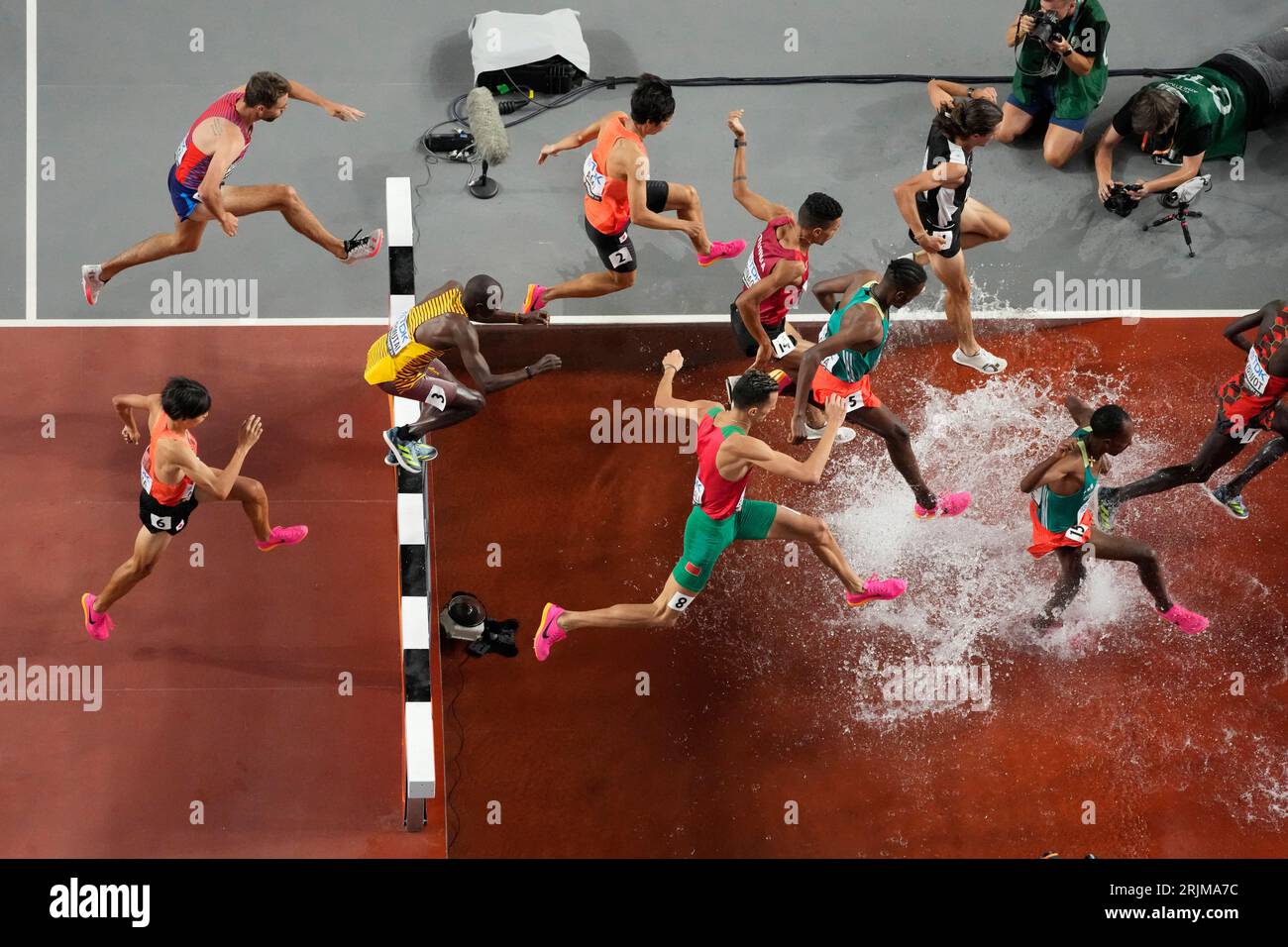 Athletes compete in the Men's 3000-meters steeplechase during the World ...