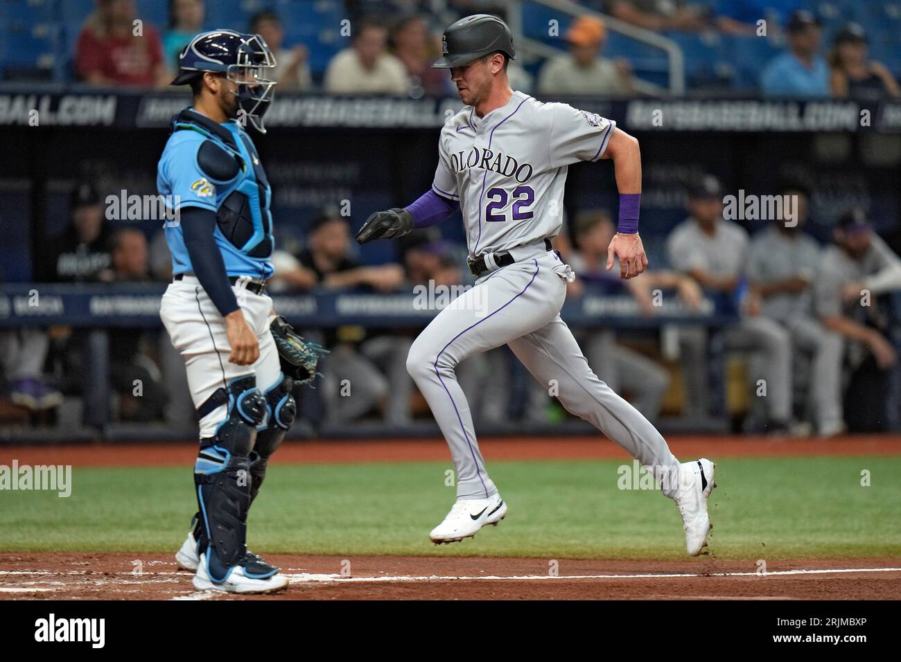 Colorado Rockies' Nolan Jones (22) scores in front of Tampa Bay Rays ...