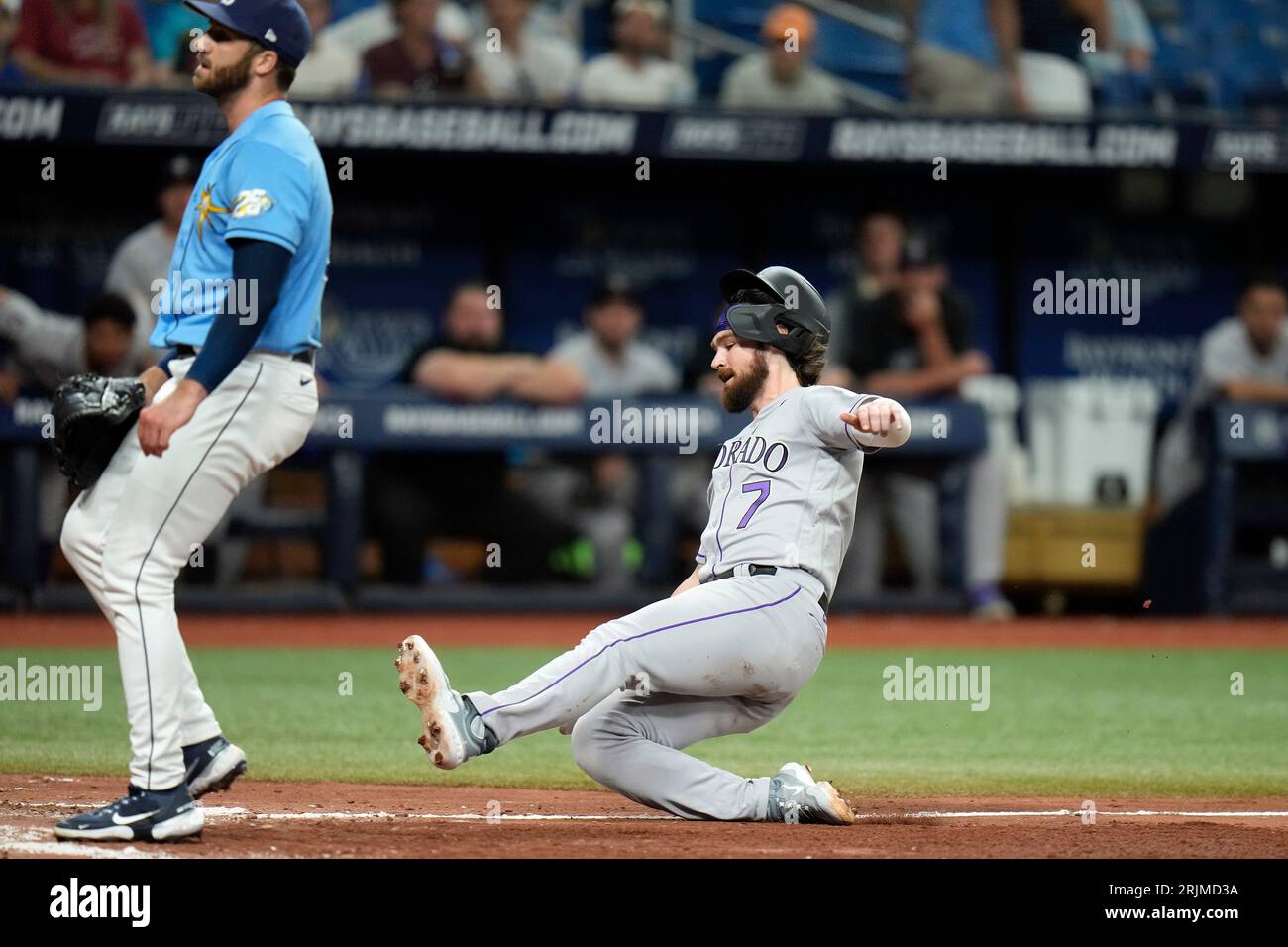 Colorado Rockies' Brendan Rodgers (7) scores on a wild pitch by Tampa ...