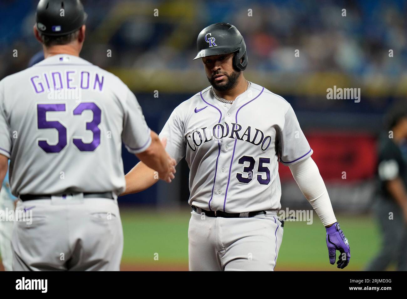 Colorado Rockies' Elias Diaz (35) celebrates with first base coach ...